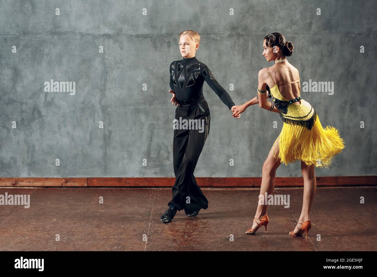 Young couple dancers dancing ballroom dance cha cha cha Stock Photo - Alamy