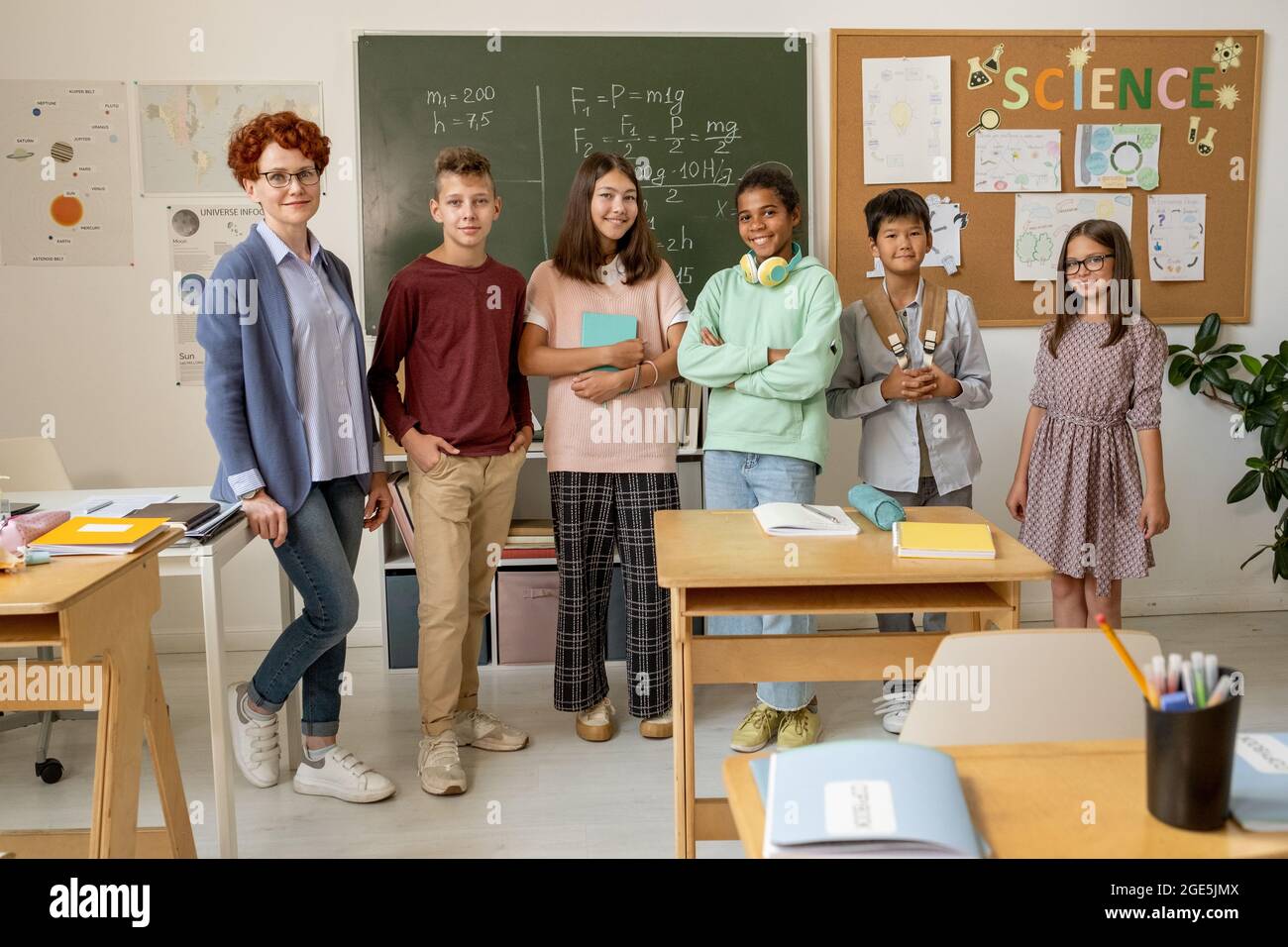 Young successful teacher and group of secondary school students ...