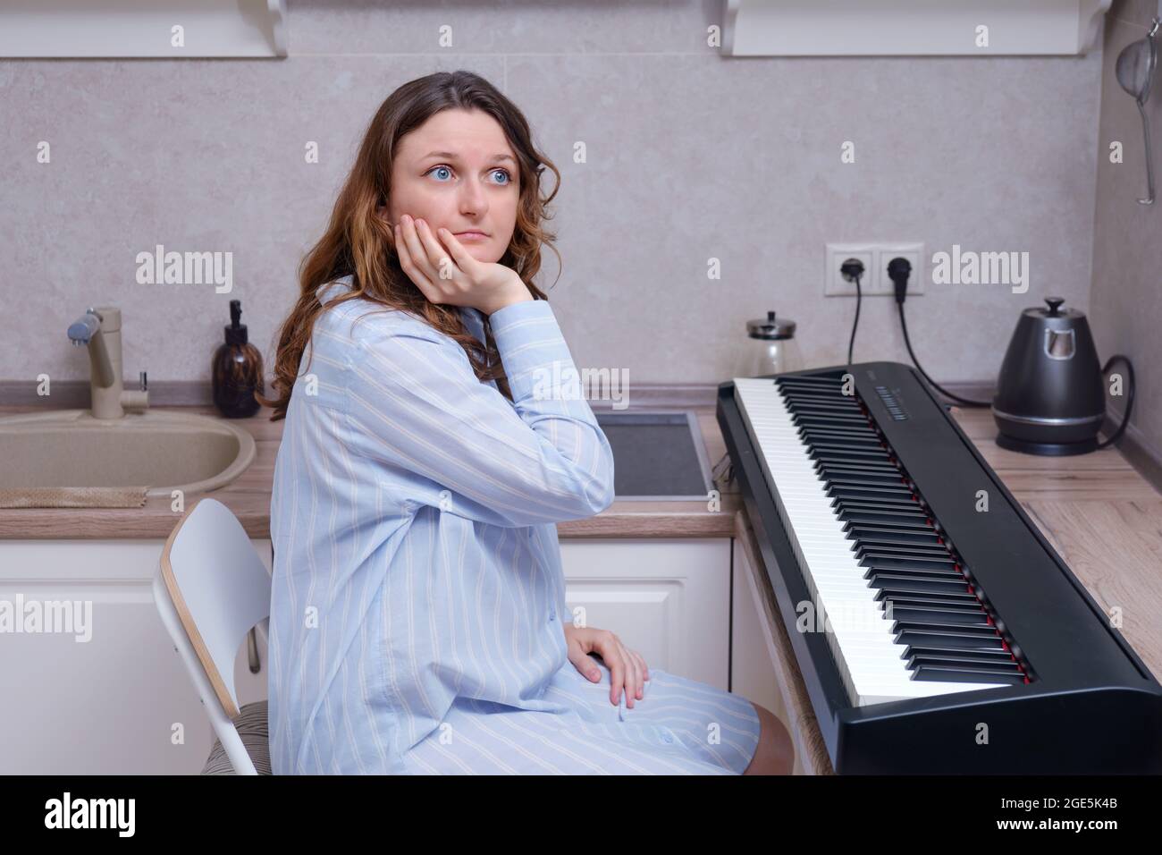 Problems of learning to play a musical instrument at home. Woman sad of ...