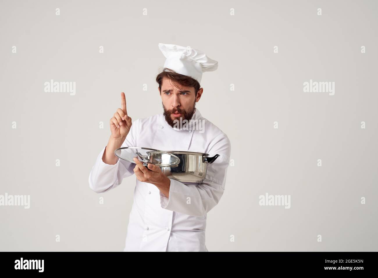 male chef with a saucepan in his hands cooking food service work Stock ...