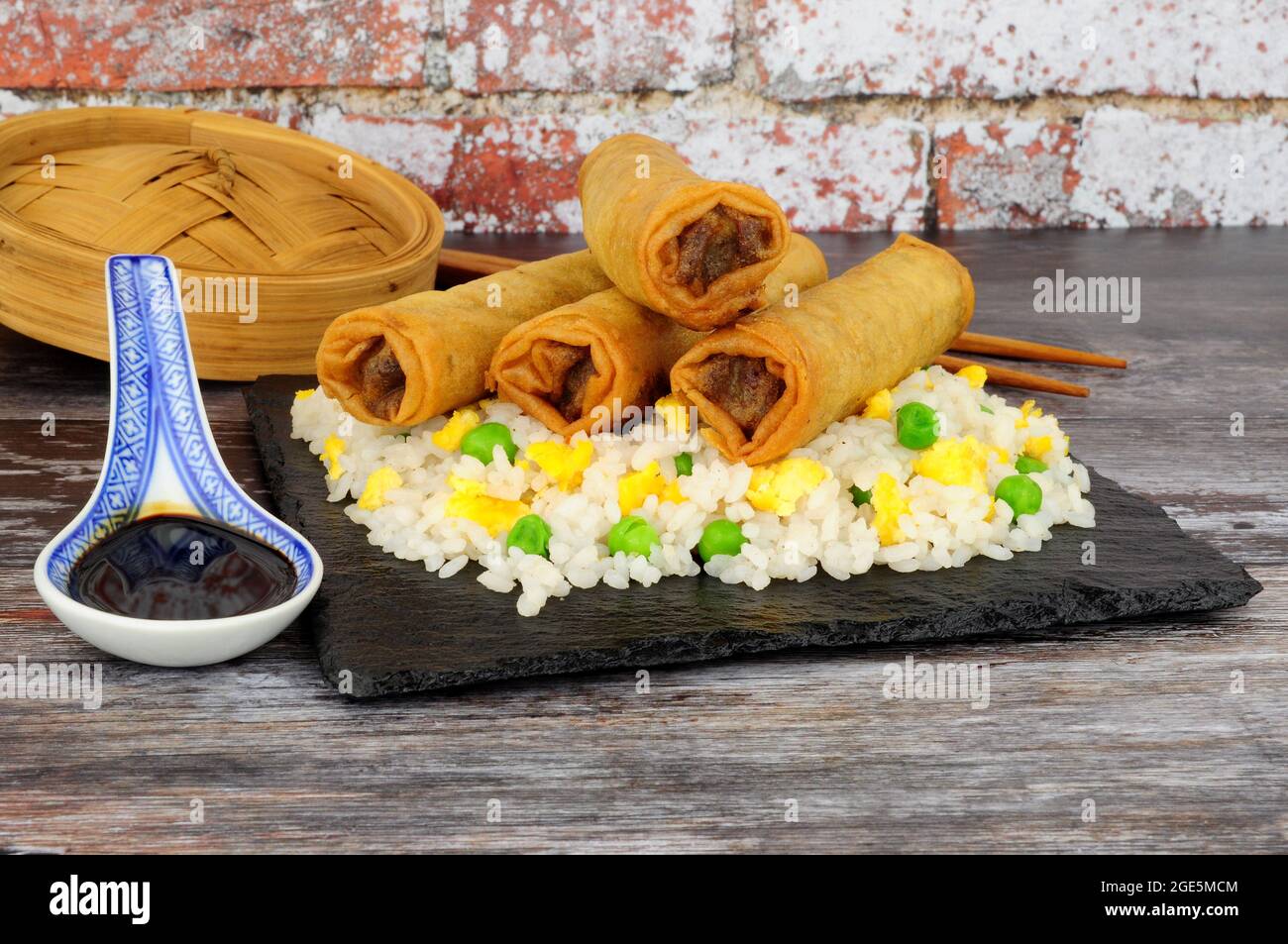 Chinese crispy duck and vegetable filled spring rolls with egg rice on ...