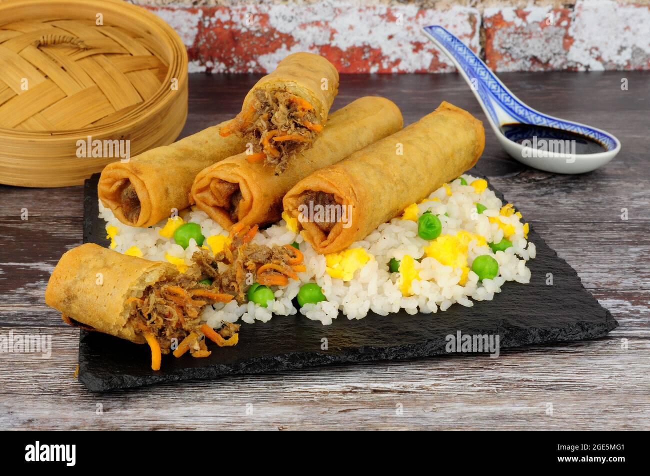 Chinese crispy duck and vegetable filled spring rolls with egg rice on ...