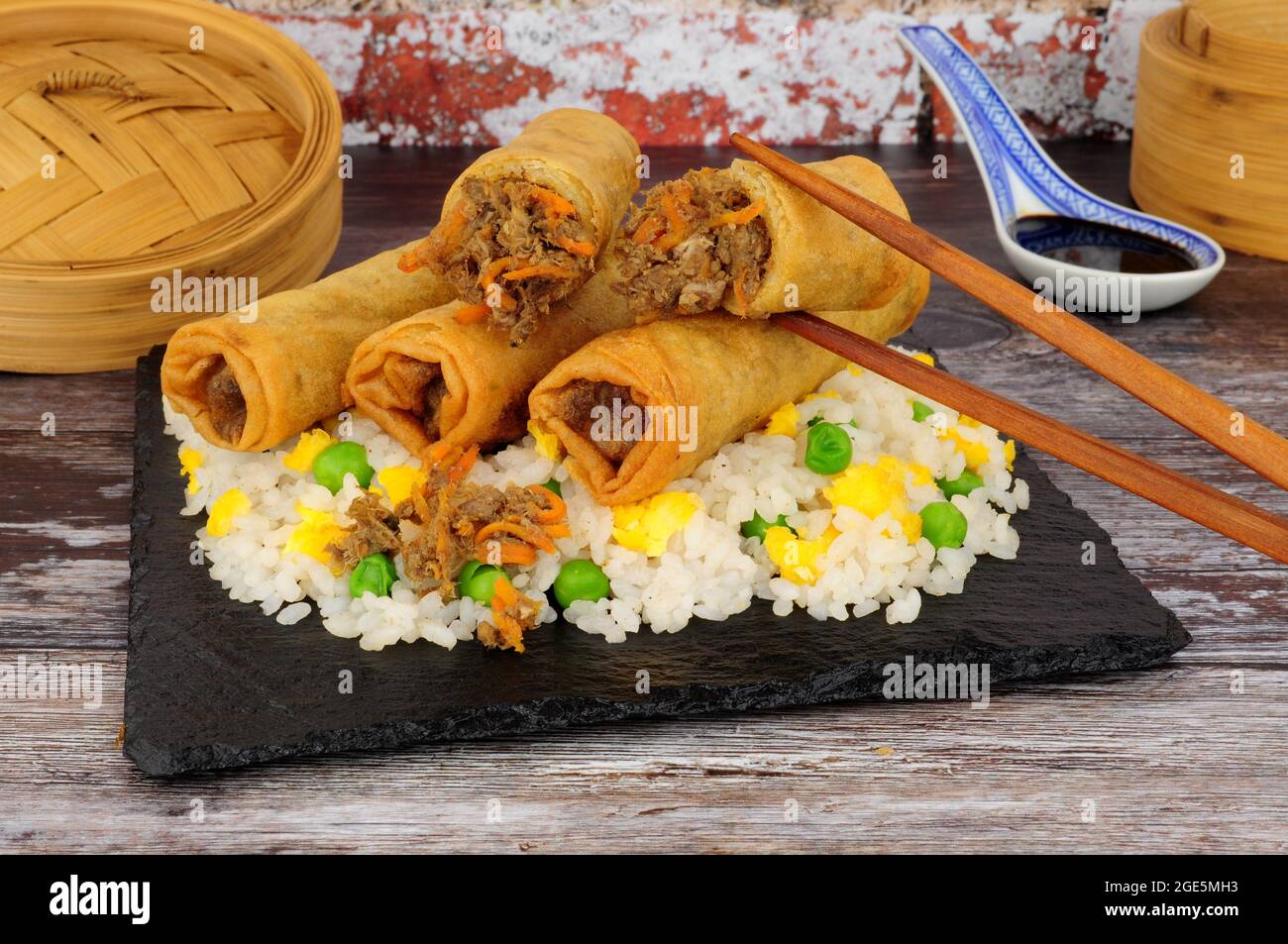 Chinese crispy duck and vegetable filled spring rolls with egg rice on ...