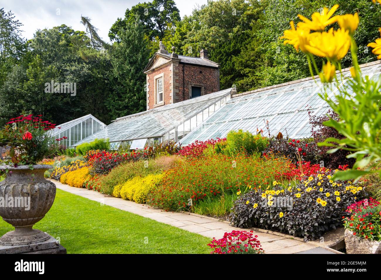 walled garden with flowers in front of the orangery glasshouse at ...