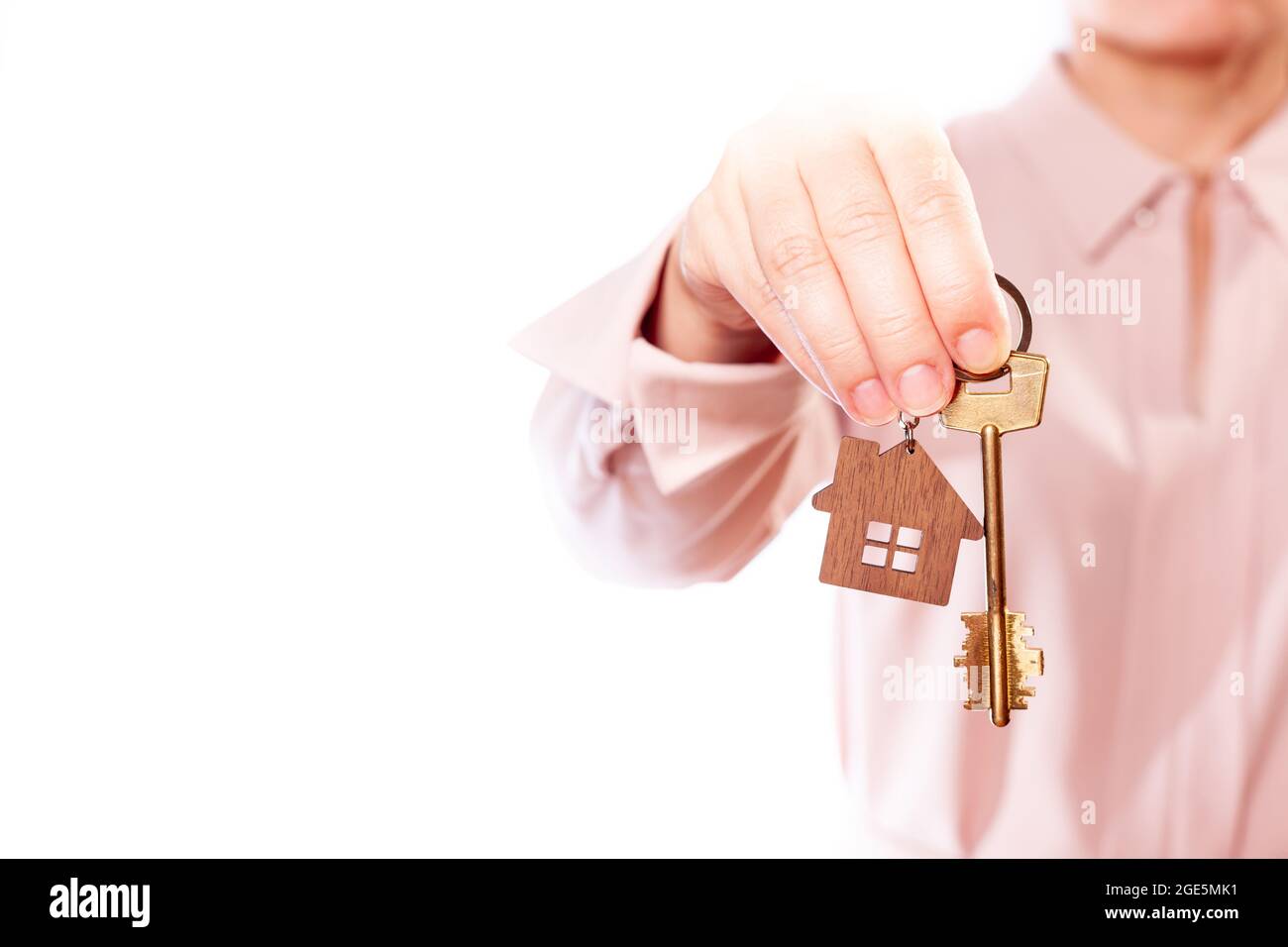 Realtor holds key to house, rental housing, isolate on white background ...