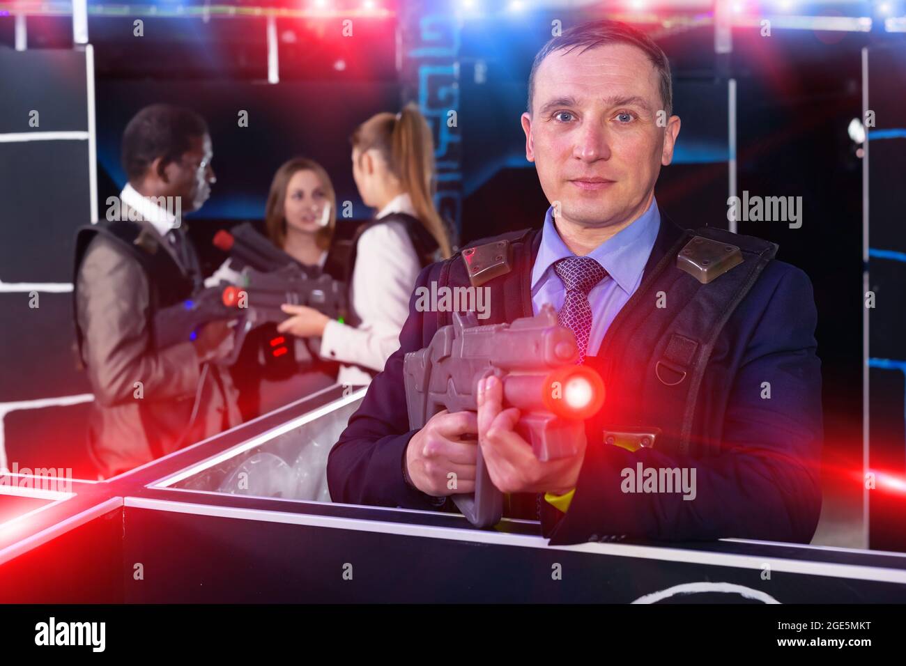 Man holding laser gun and playing laser tag Stock Photo - Alamy