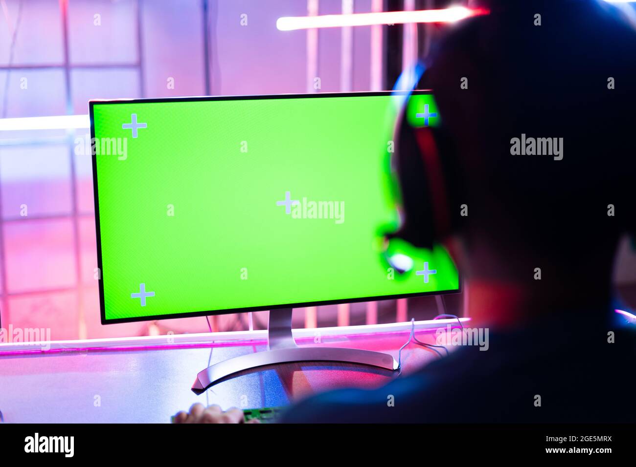 Shoulder shot of professional video gamer playing video game on Agreen ...