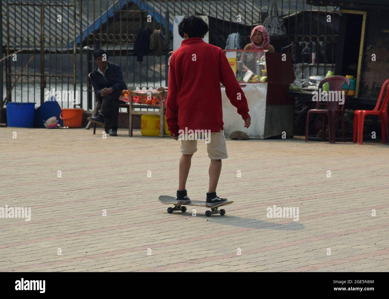 Backside shot of a skateboarder showing his skate boarding skills while ...
