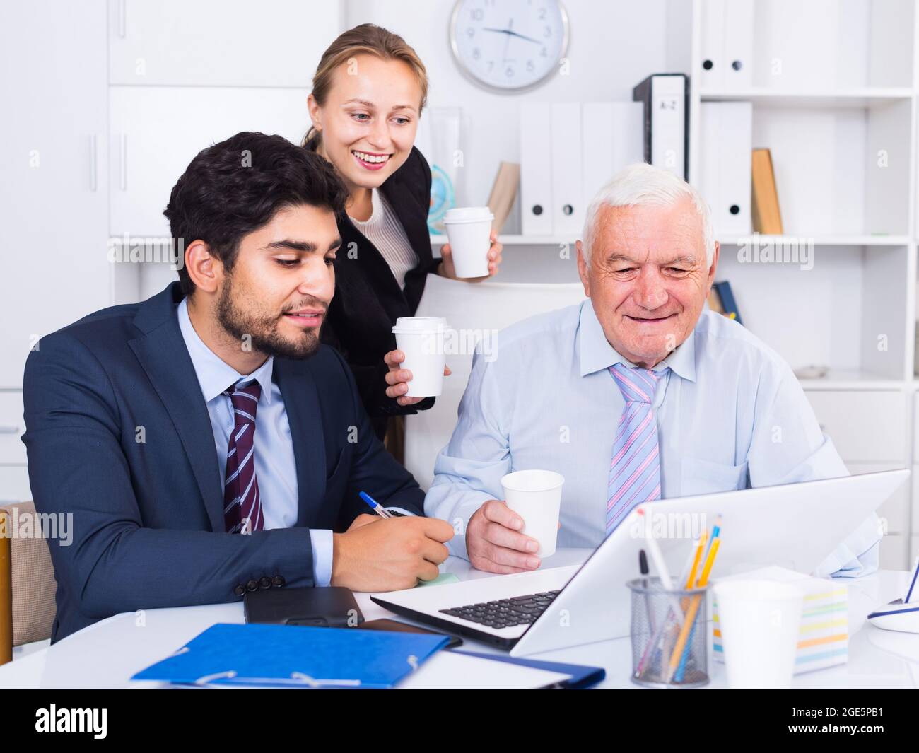 Office workers are demonstrating reports on laptop to mature boss Stock ...