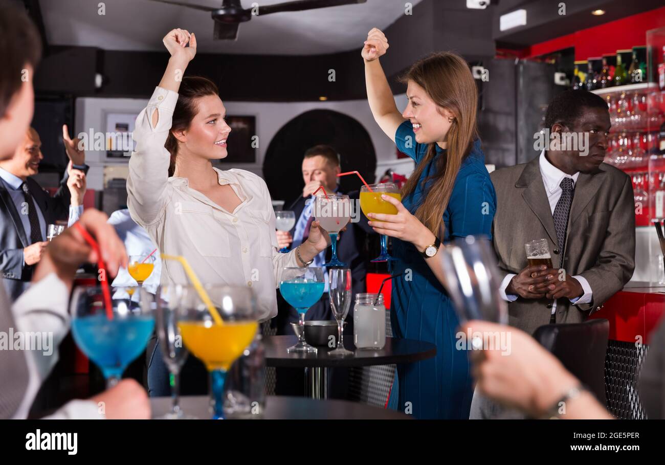 Two girls talking on corporate party Stock Photo - Alamy