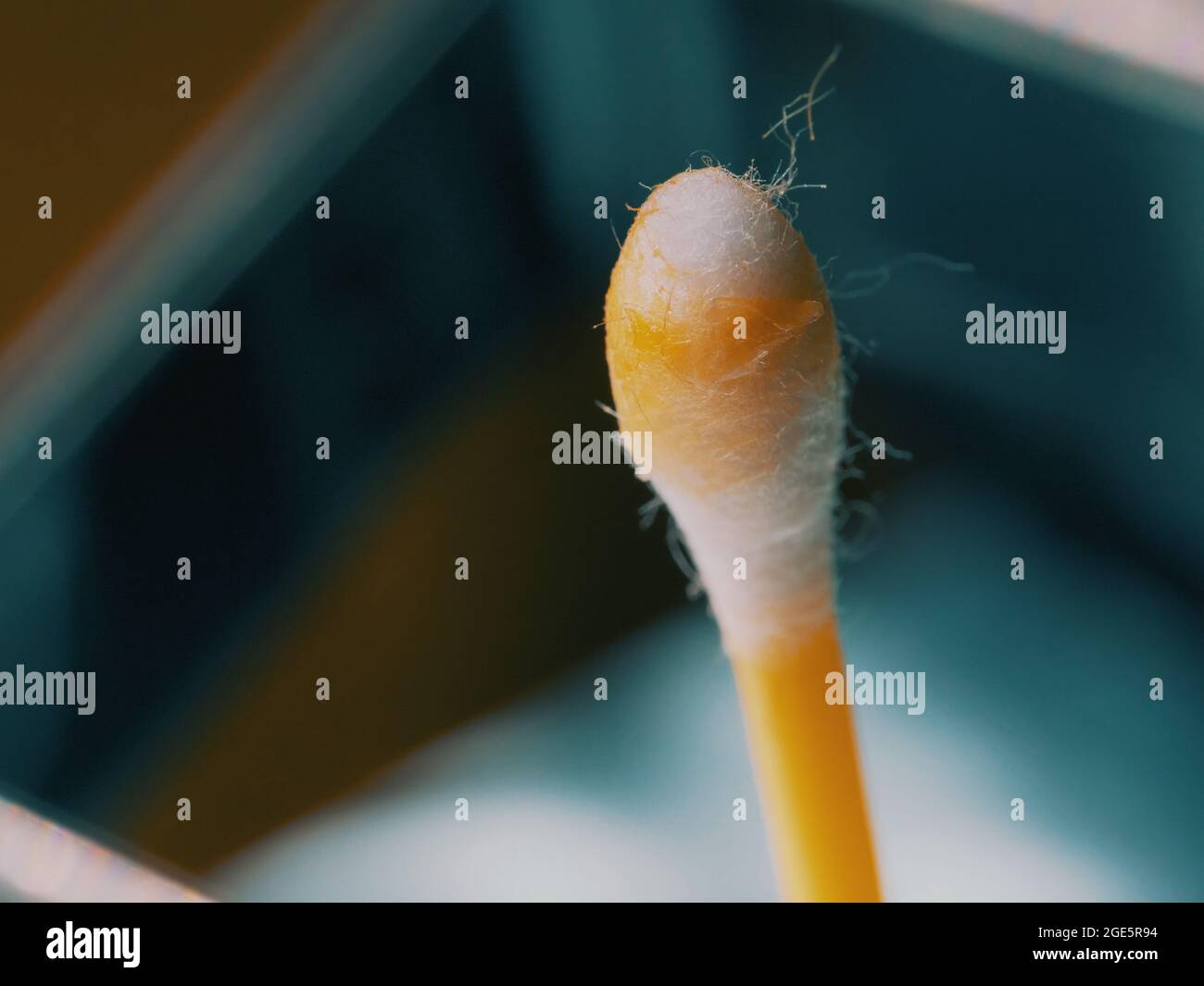 Earwax on a cotton swab, macro photo. Earwax, also known by the medical ...