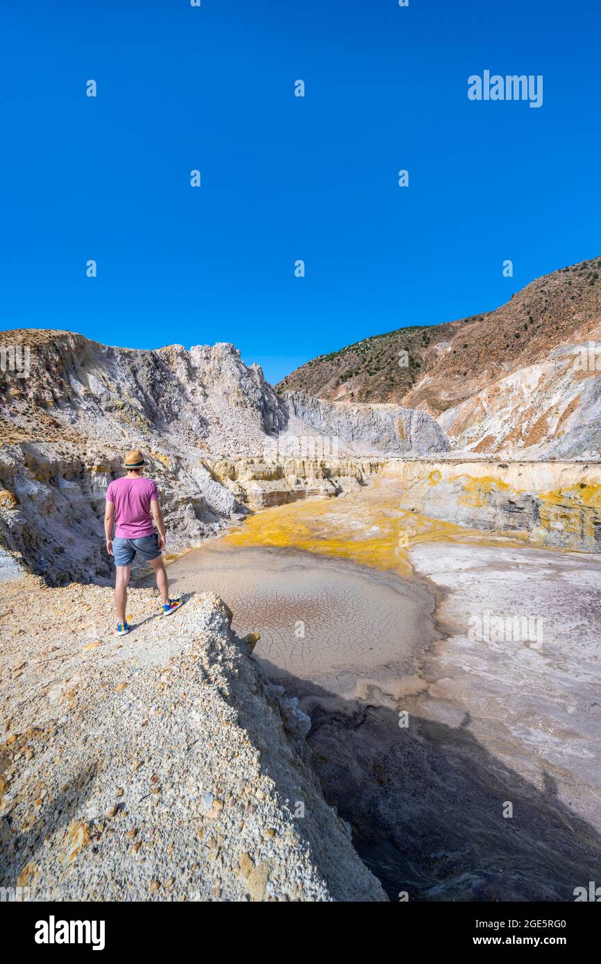 Young tourist at a crater, volcano caldera with pumice fields, yellow ...