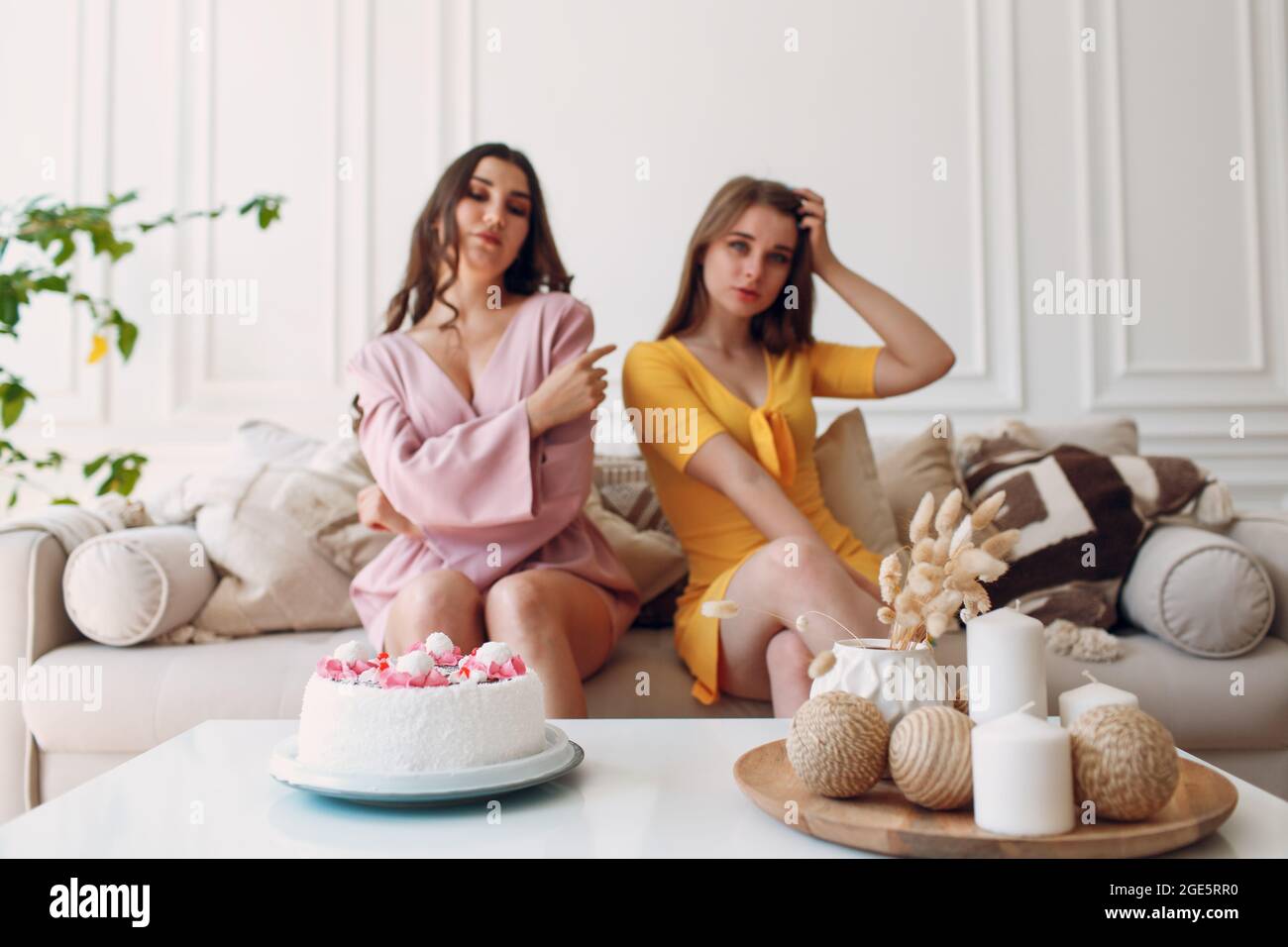 Women happy friends at home sitting and smiling with white birthday ...