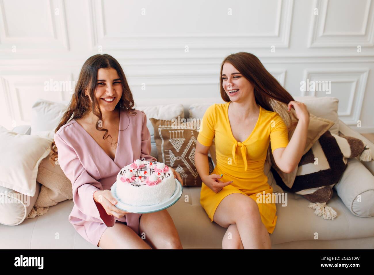 Women happy friends at home sitting and smiling with white birthday ...