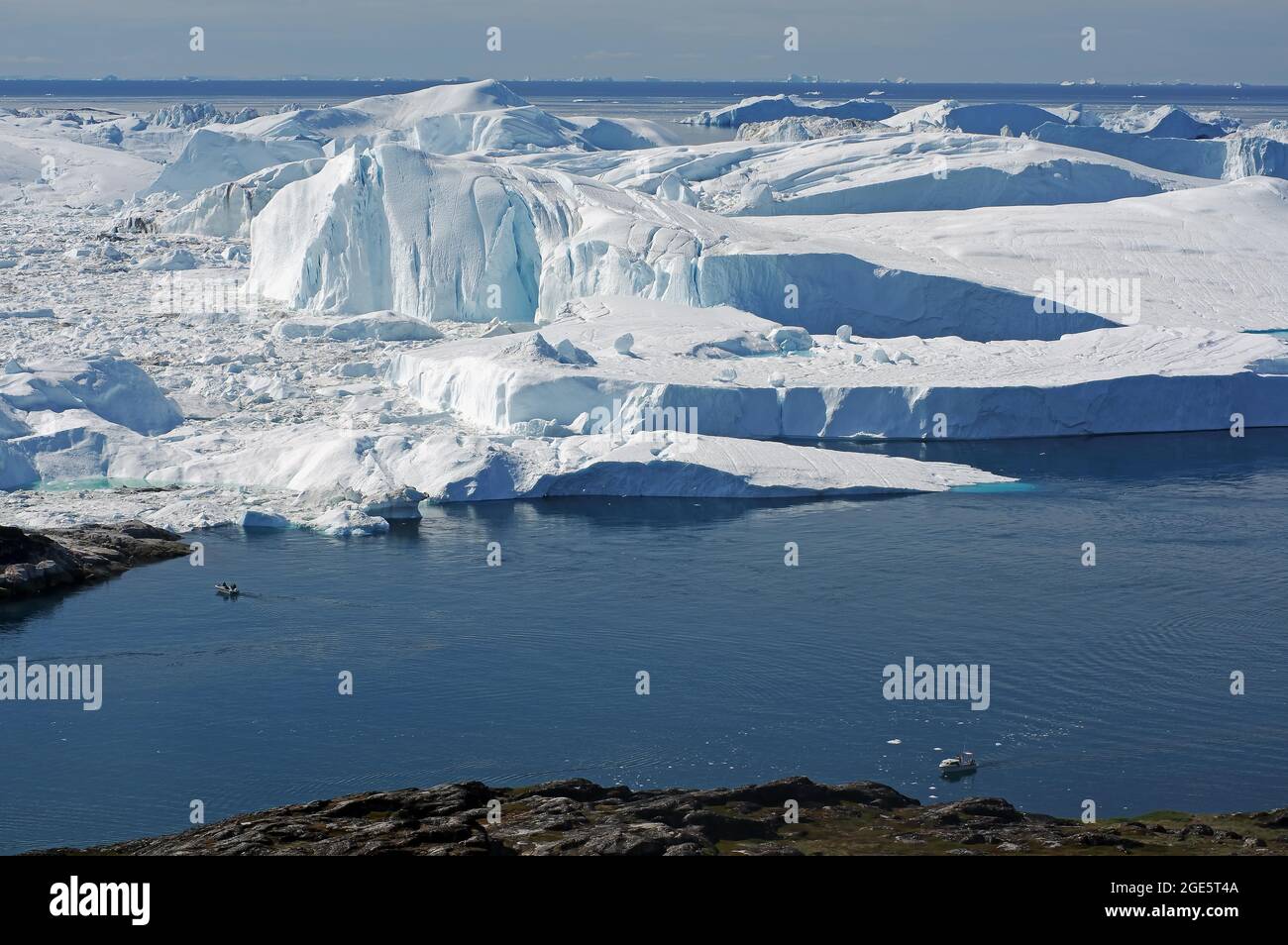 View over the ice fjord with icebergs, wide bay with icebergs behind ...