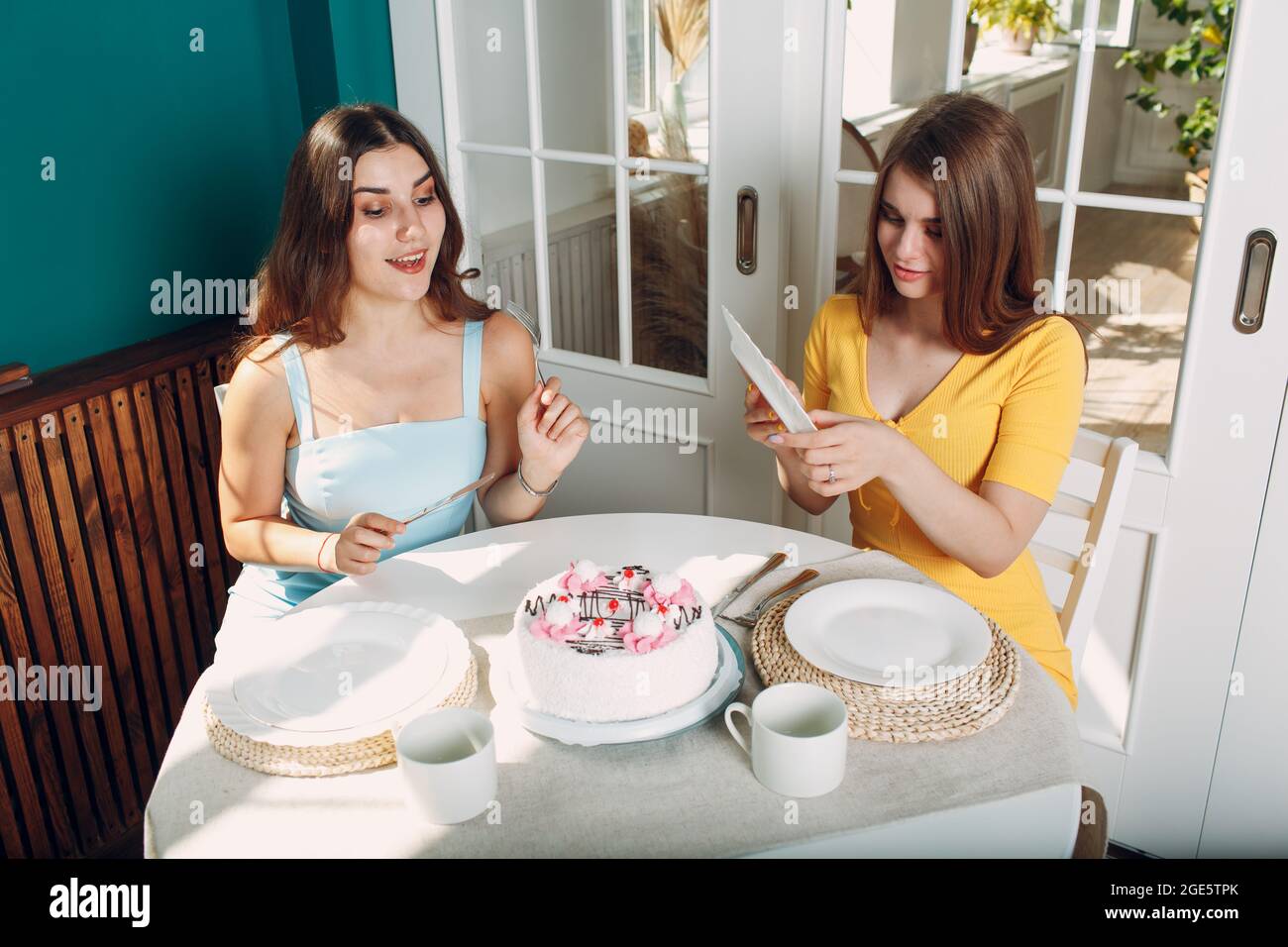 Women happy friends at home sitting and smiling with white birthday ...