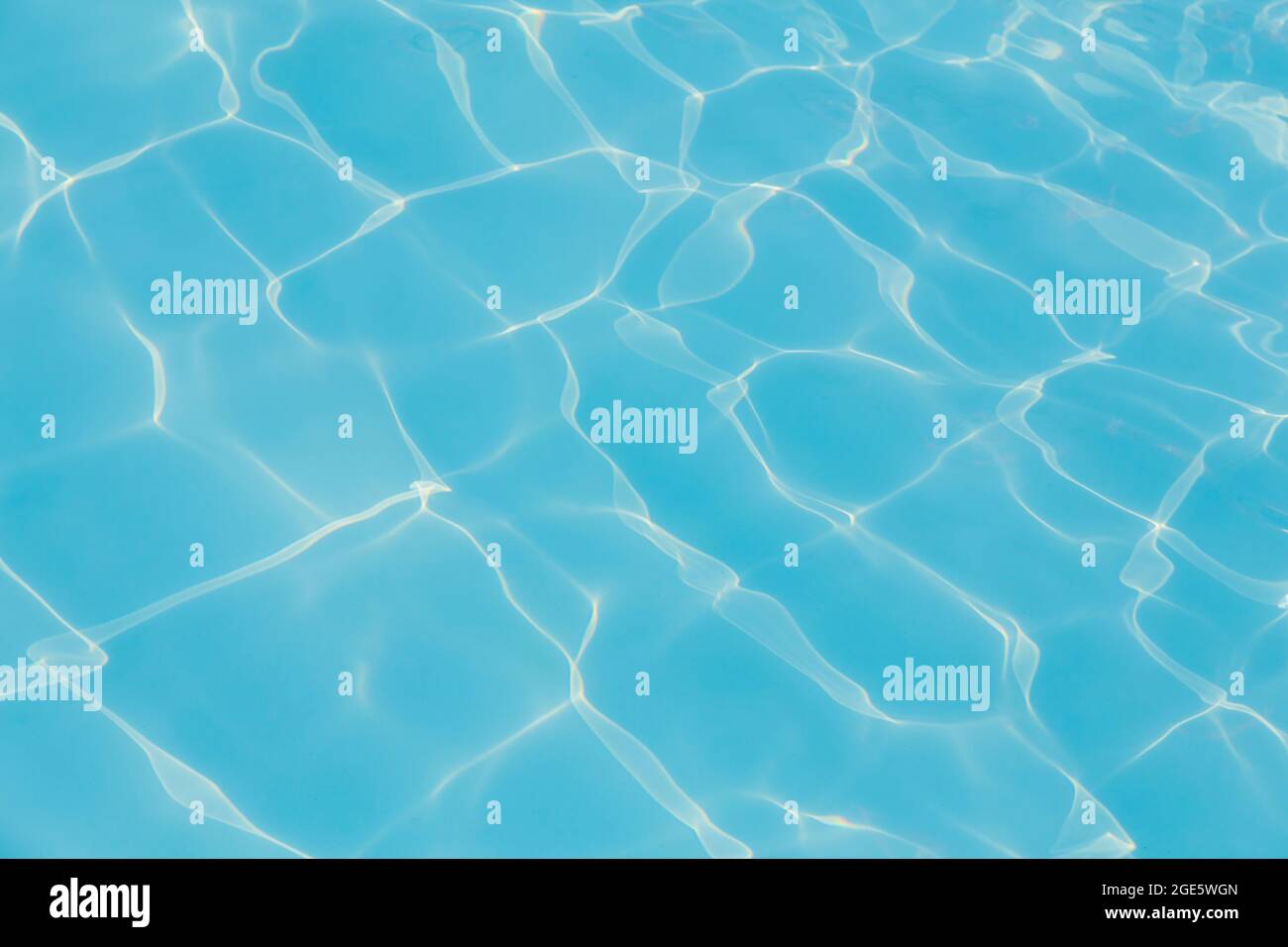 Blue pool water with sun reflections background Stock Photo - Alamy