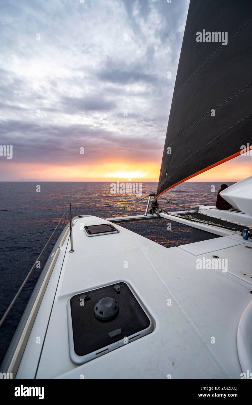 Foresail and deck with net of a sailing catamaran at sunset, sailing ...