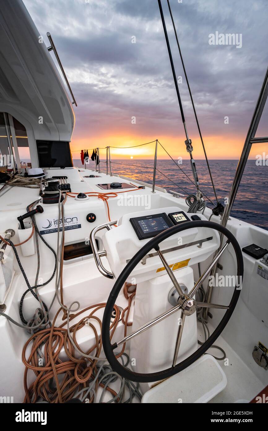 Steering wheel in the cockpit on the deck of a sailing catamaran at ...