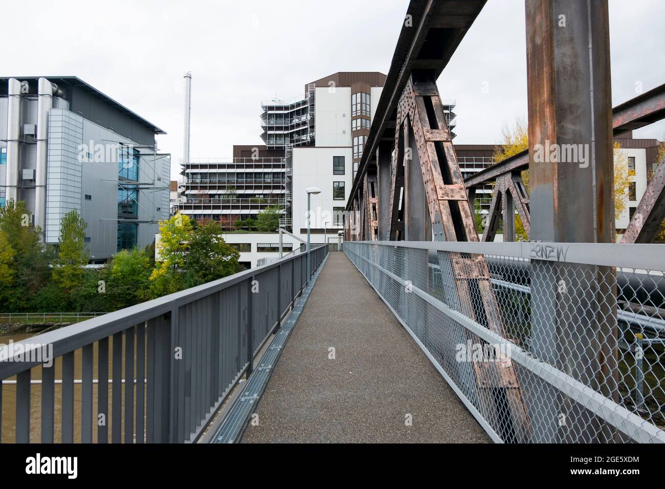 A grey, steel, metal pedestrian walkway over a highway, road. In ...