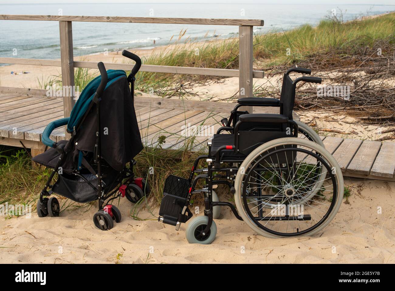 Wheelchair and stroller on ramp at the beach close up Stock Photo - Alamy