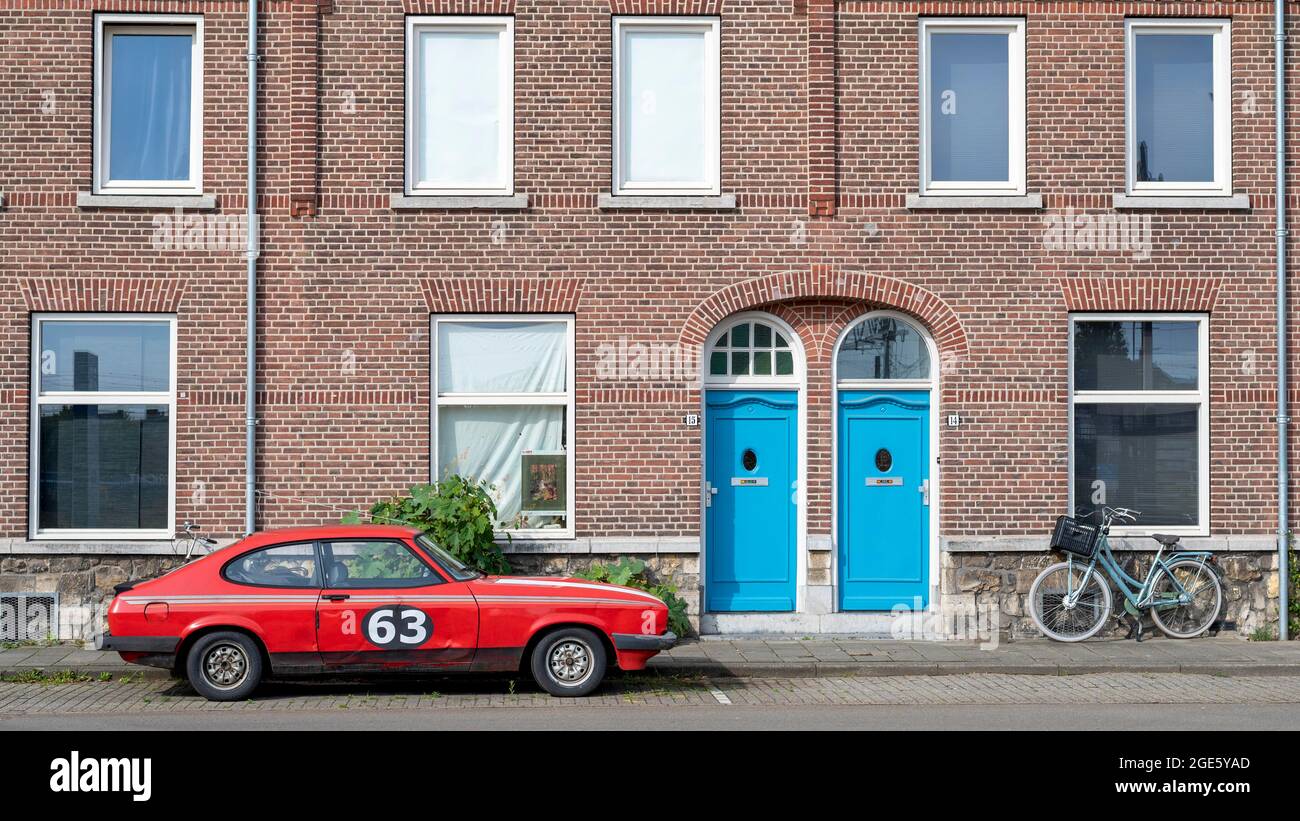 Street scene with red racing car and traditional Dutch bicycle ...