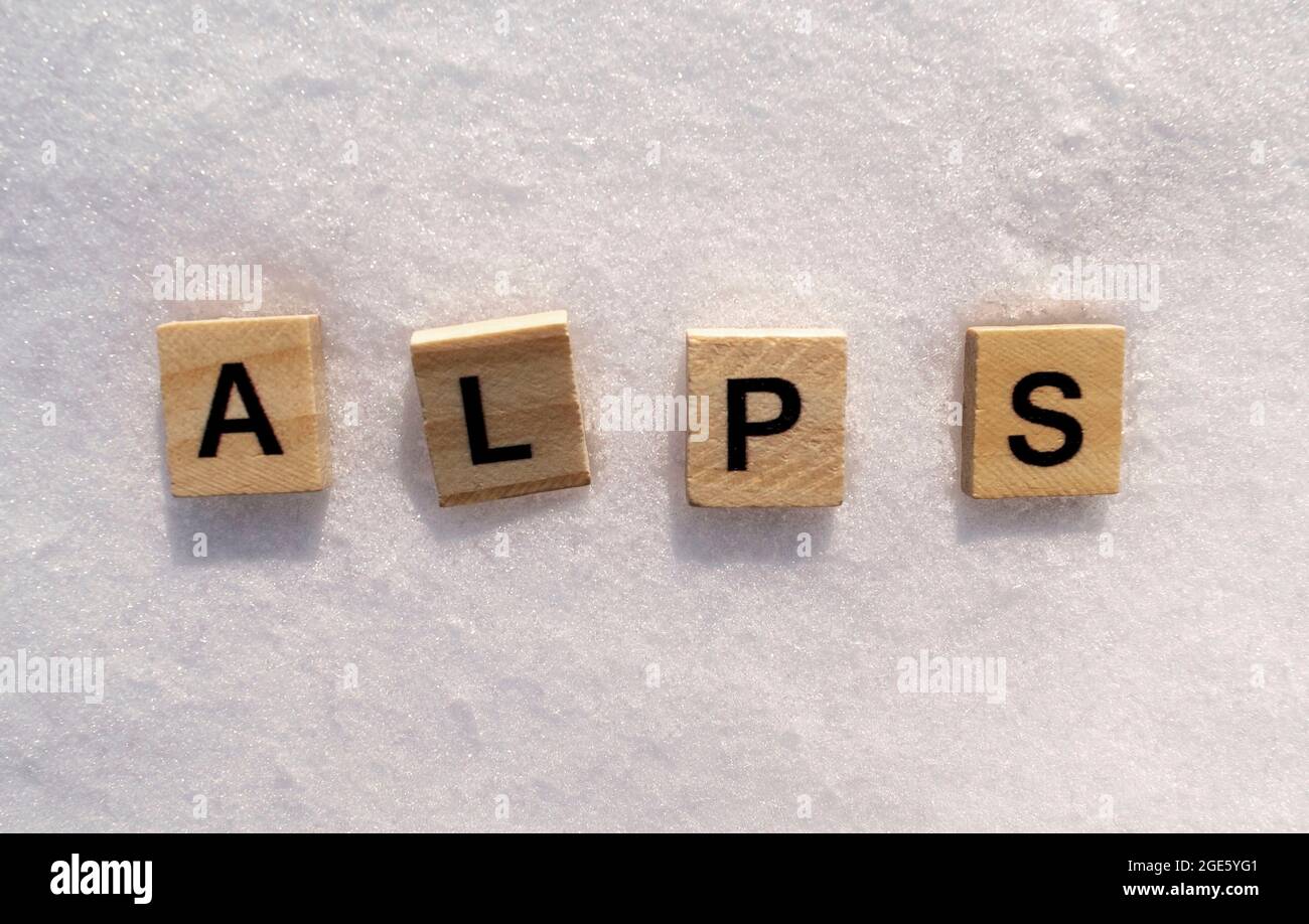 Alps word on a white clean snow. Alps mountains is written on a snow ...