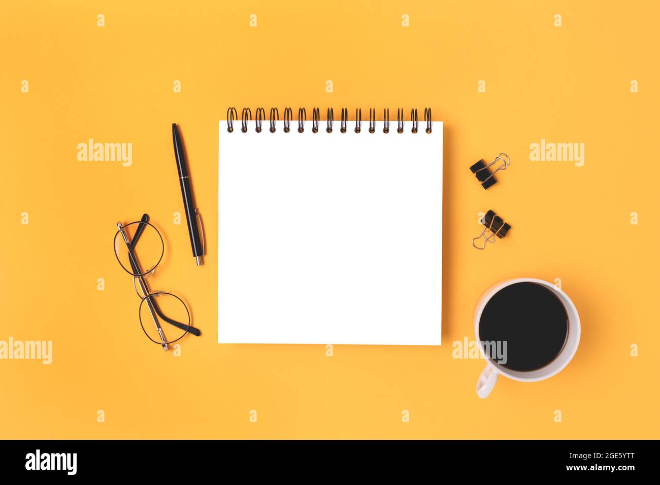 Workspace with square notepad mockup, stationery and coffee cup on a ...