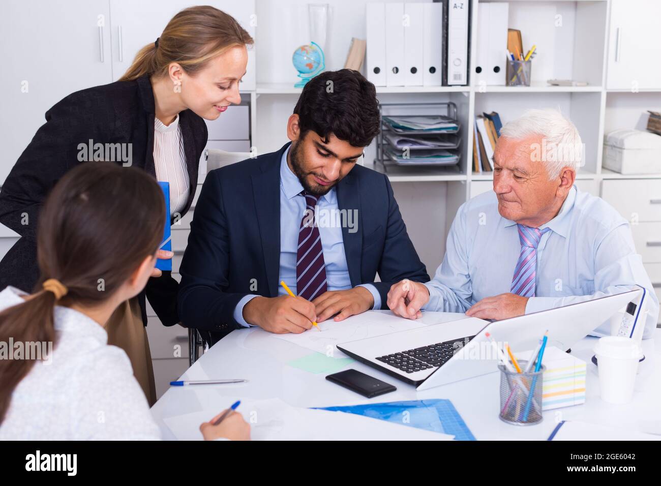 Business colleagues working financial reports hi-res stock photography ...