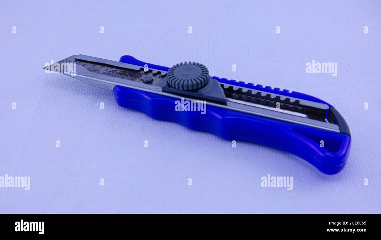 A blue cutting knife on a white background Stock Photo - Alamy