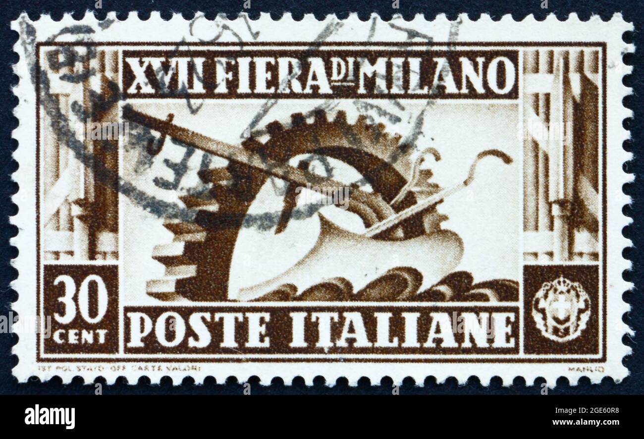 ITALY - CIRCA 1936: a stamp printed in the Italy shows Cogwheel and ...