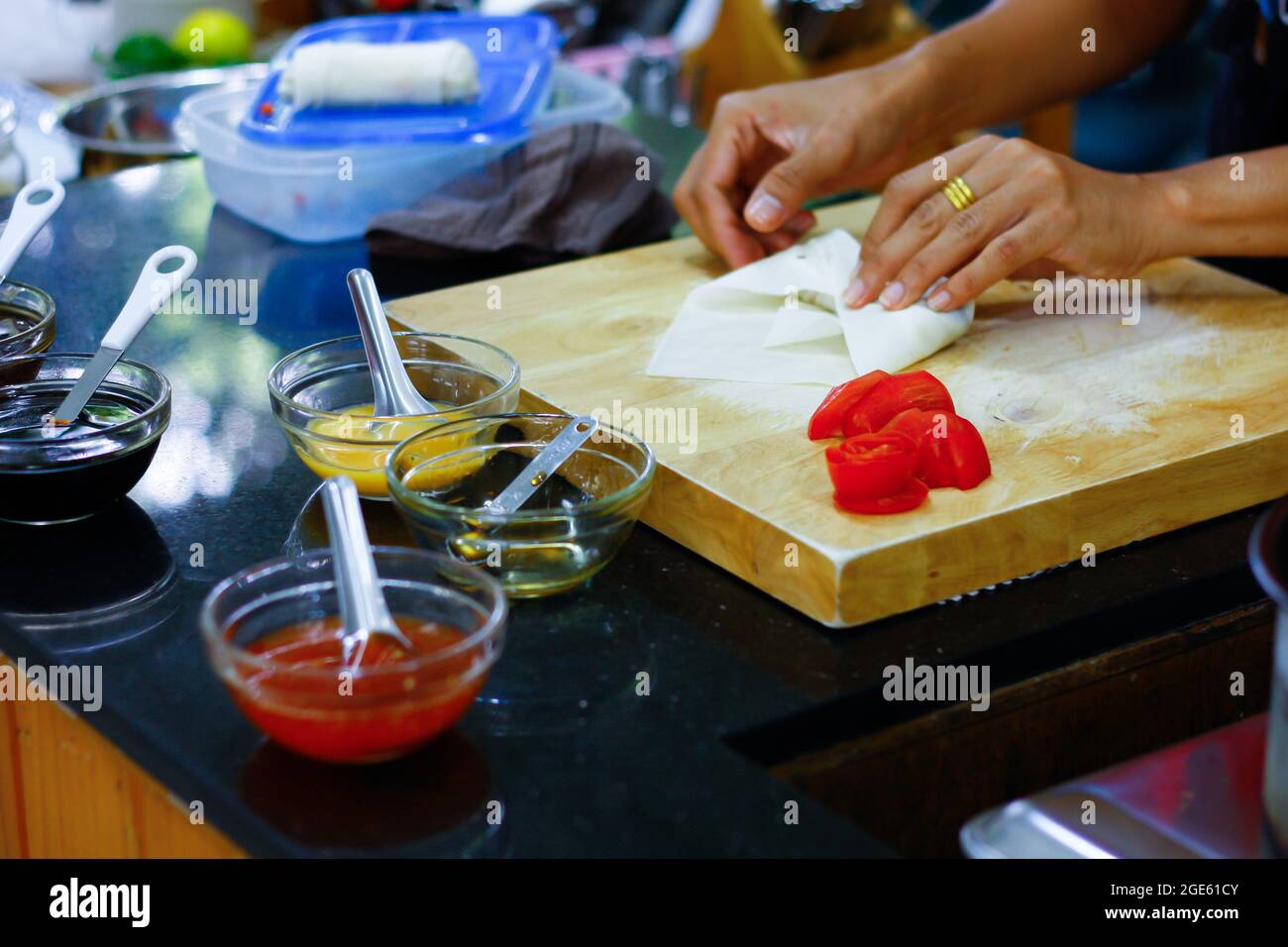 Hands wrapping spring rolls hi-res stock photography and images - Alamy