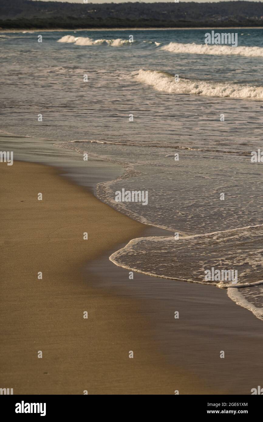 gentle waves ebbing on a beach Stock Photo - Alamy