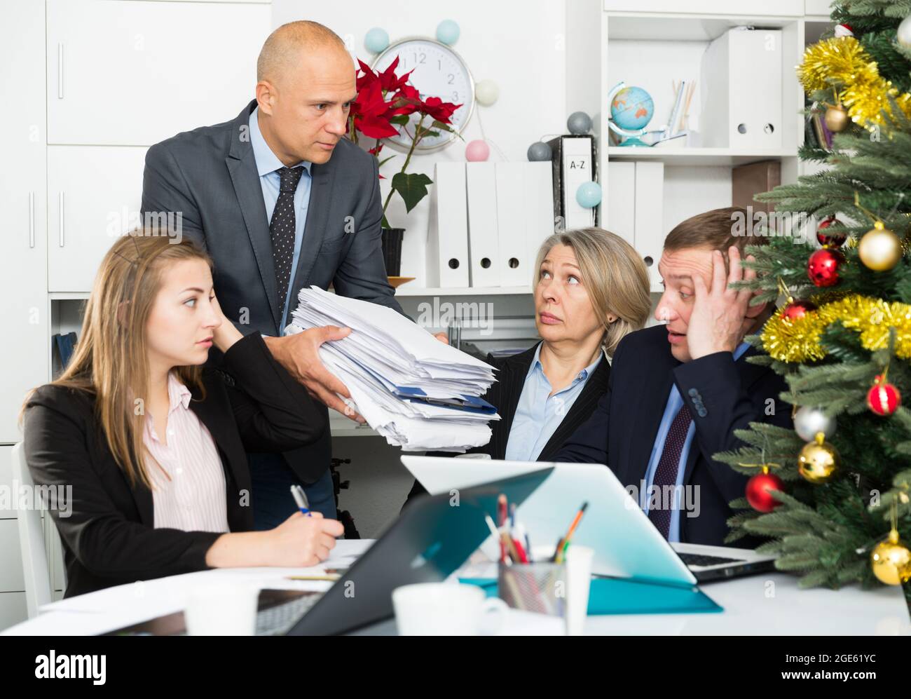 Coworkers unhappy with extra work before Christmas Stock Photo - Alamy