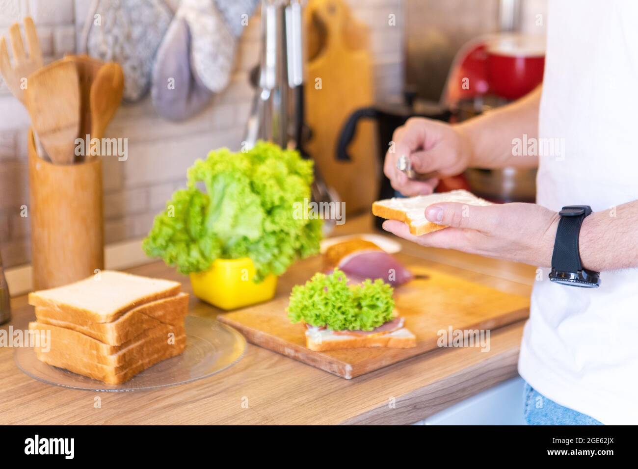 man making sandwich on the kitchen copy space Stock Photo - Alamy