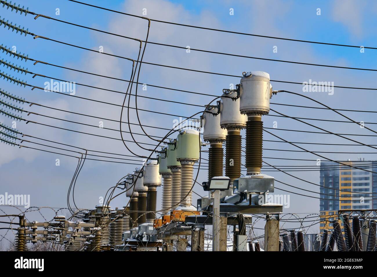 Power plant in winter with electricity transformers covered with snow ...