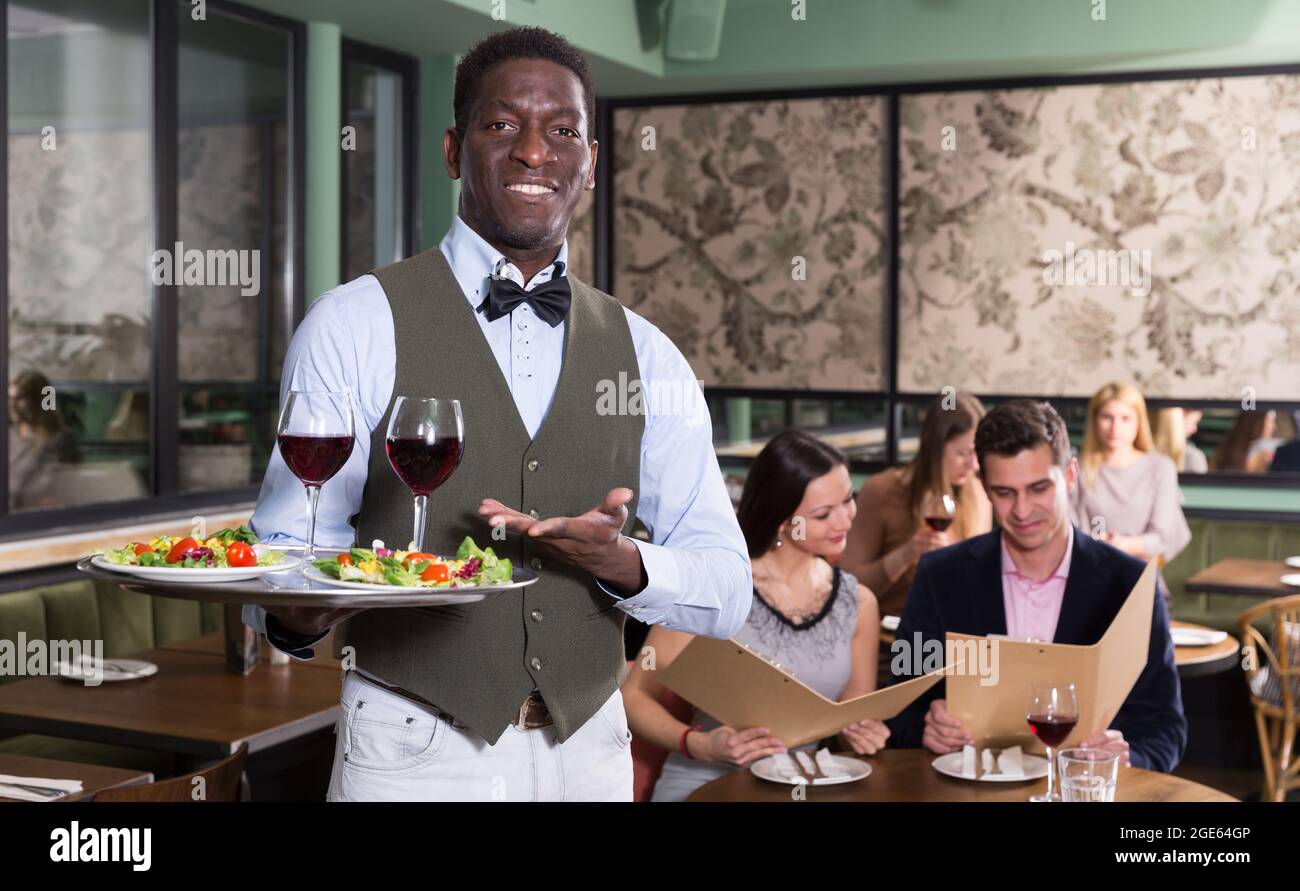 African American waiter with serving tray Stock Photo - Alamy