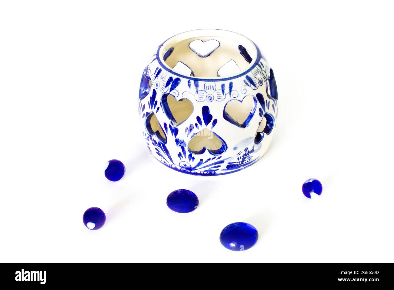 Blue decorative vase with stones on a white background Stock Photo - Alamy