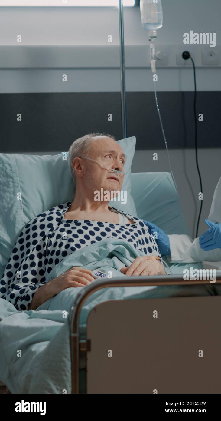 Multi ethnic medical personnel monitoring patient health condition in ...