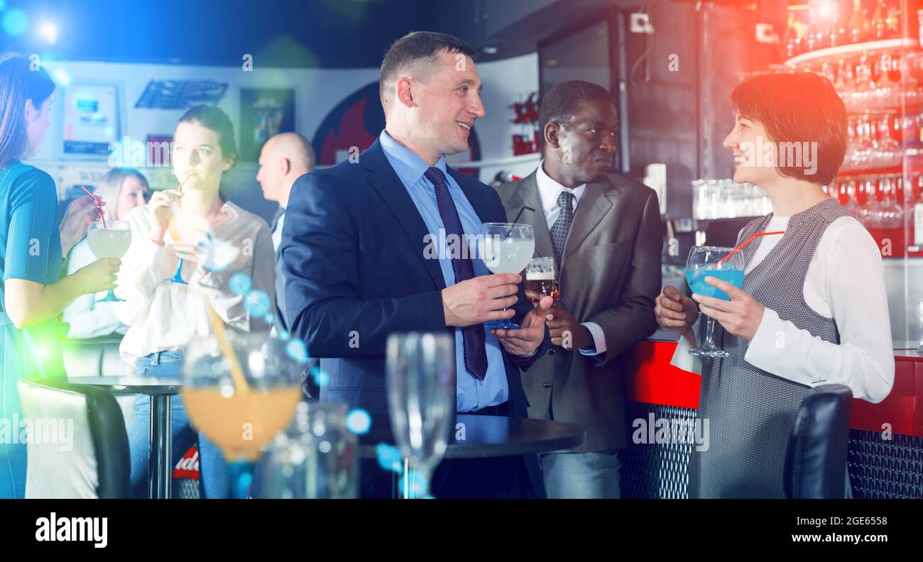 Coworkers talking at office party Stock Photo - Alamy