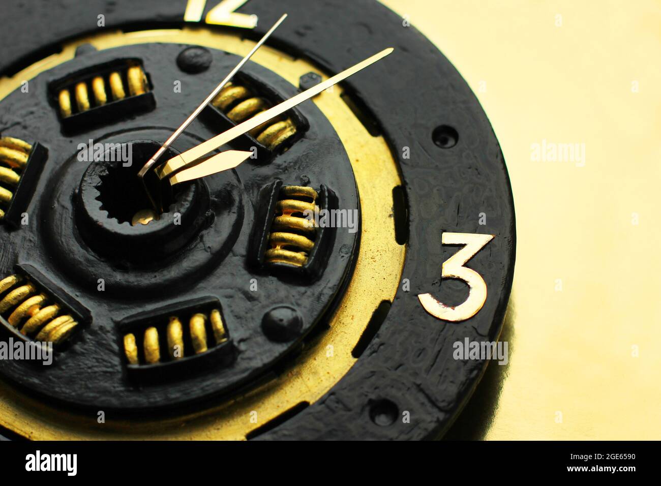 Handmade watches on a gold background. A clock from a car clutch disc ...