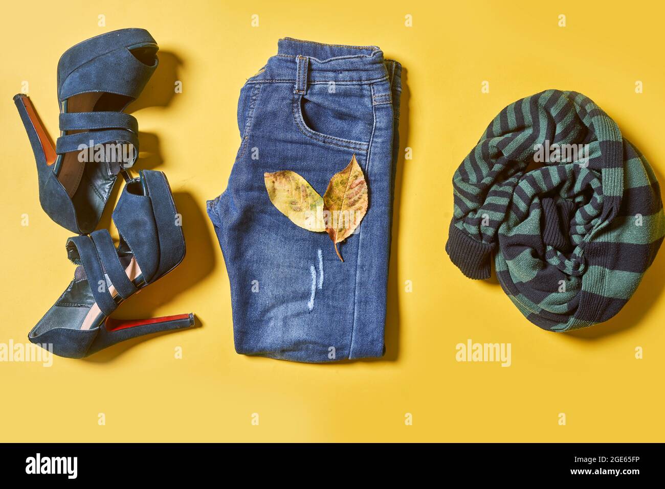 Female autumnal clothes set on yellow background. Set of women outfit ...