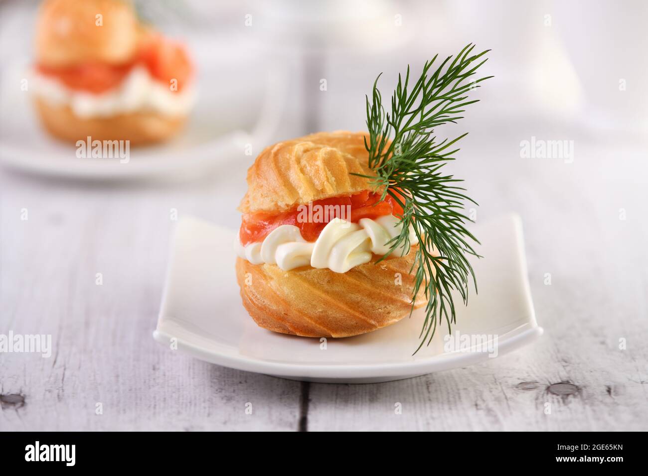 Profiteroles stuffed with cream cheese and salmon, decorated with a ...