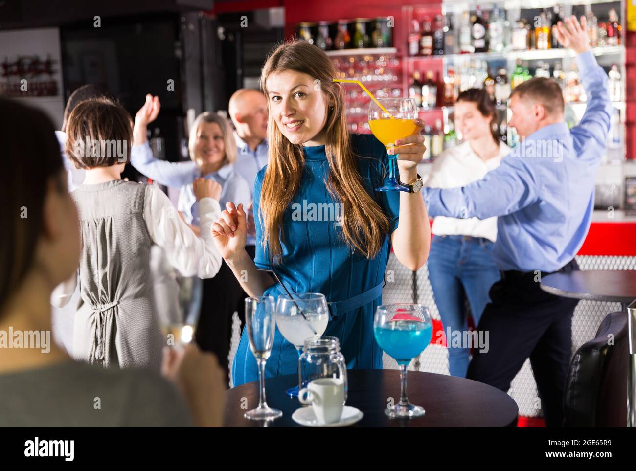 Girl drinking cocktail and dancing Stock Photo - Alamy