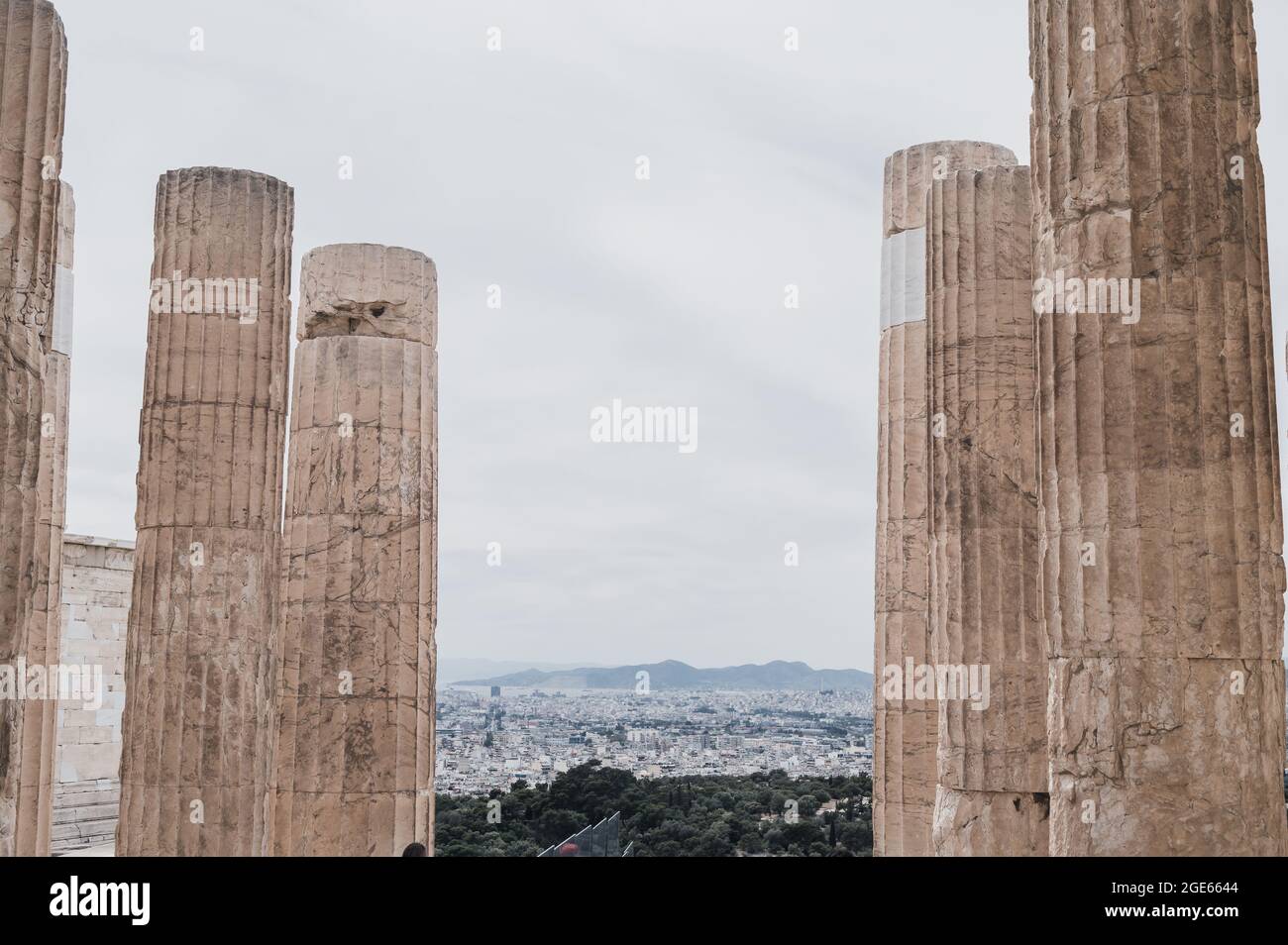 Cityscape of Athens with huge marble columns on foreground. Ruins of ...