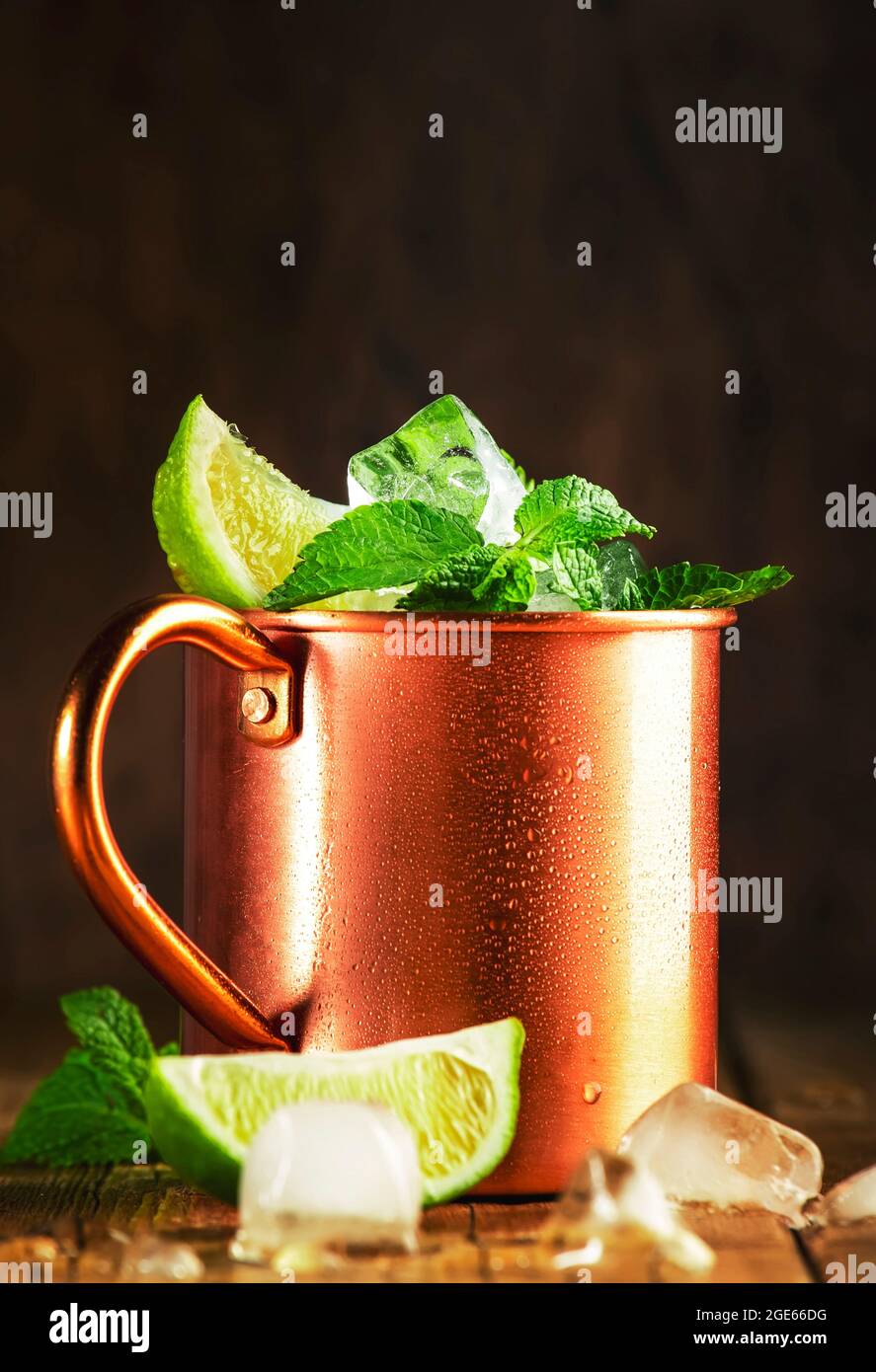 Moscow mule cocktails in copper mug with lime, ice, ginger beer, vodka ...