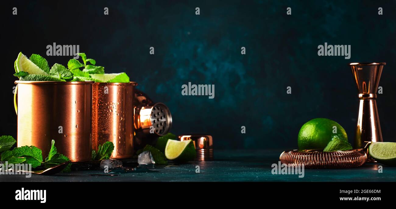 Moscow mule cocktail in copper mug with lime, ice, ginger beer, vodka ...