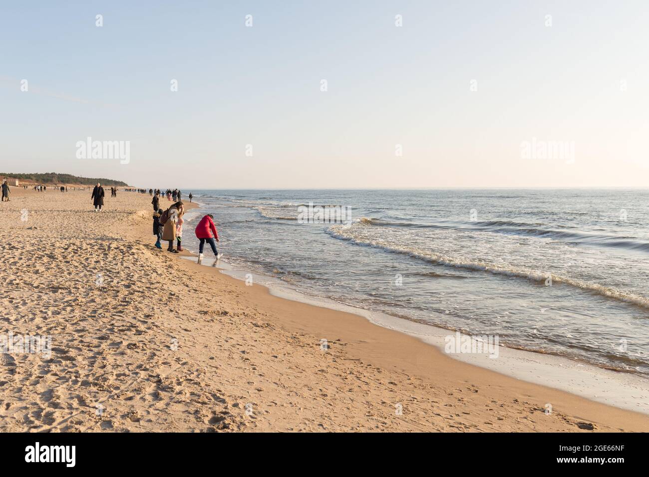 Few of people walking on the beach in spring Stock Photo - Alamy