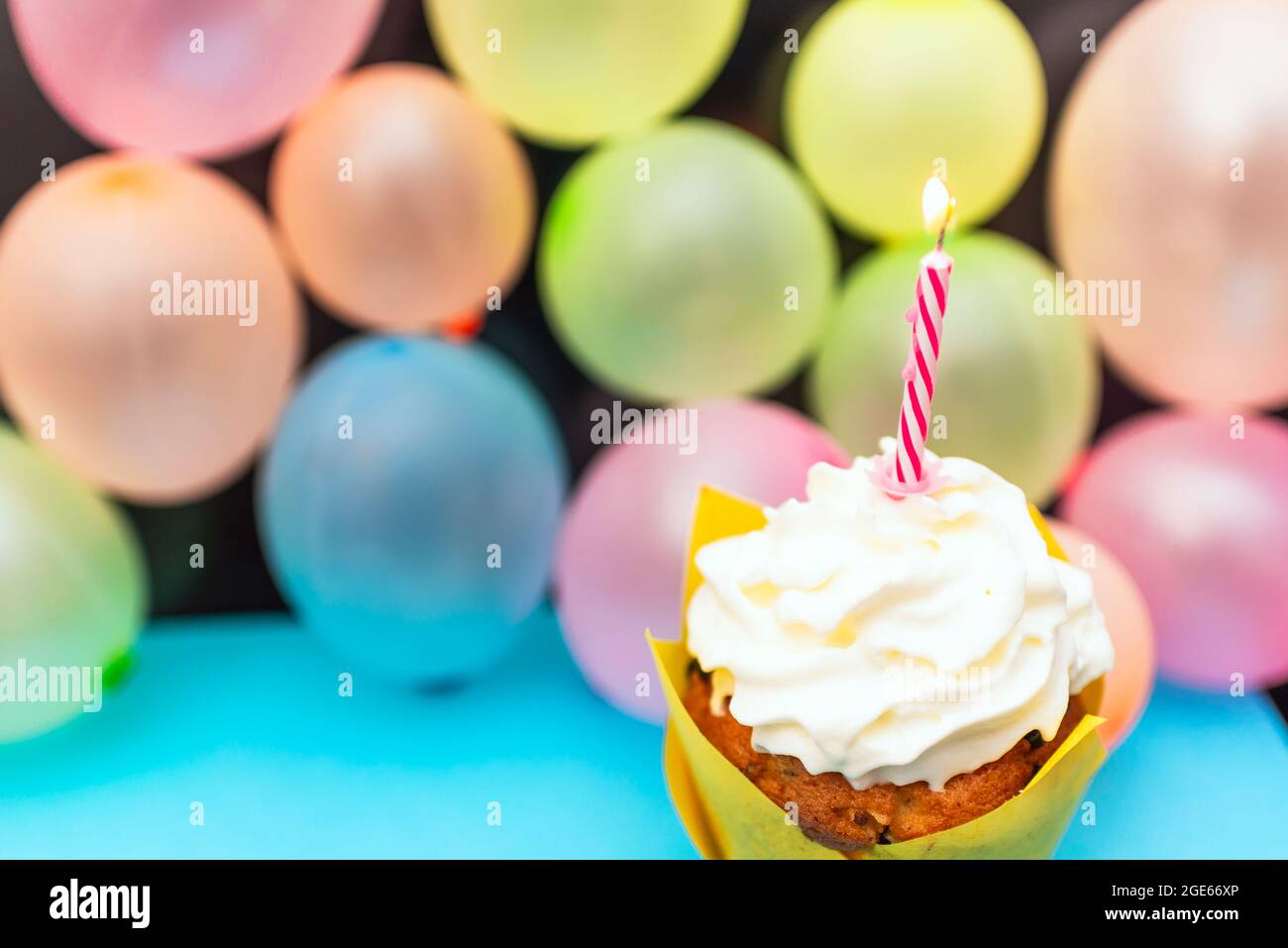 Birthday cupcake.Pastel yellow birthday cupcake with candle and blurred ...