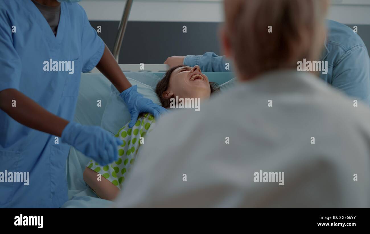 Woman in labor pushing for painful child delivery while husband ...